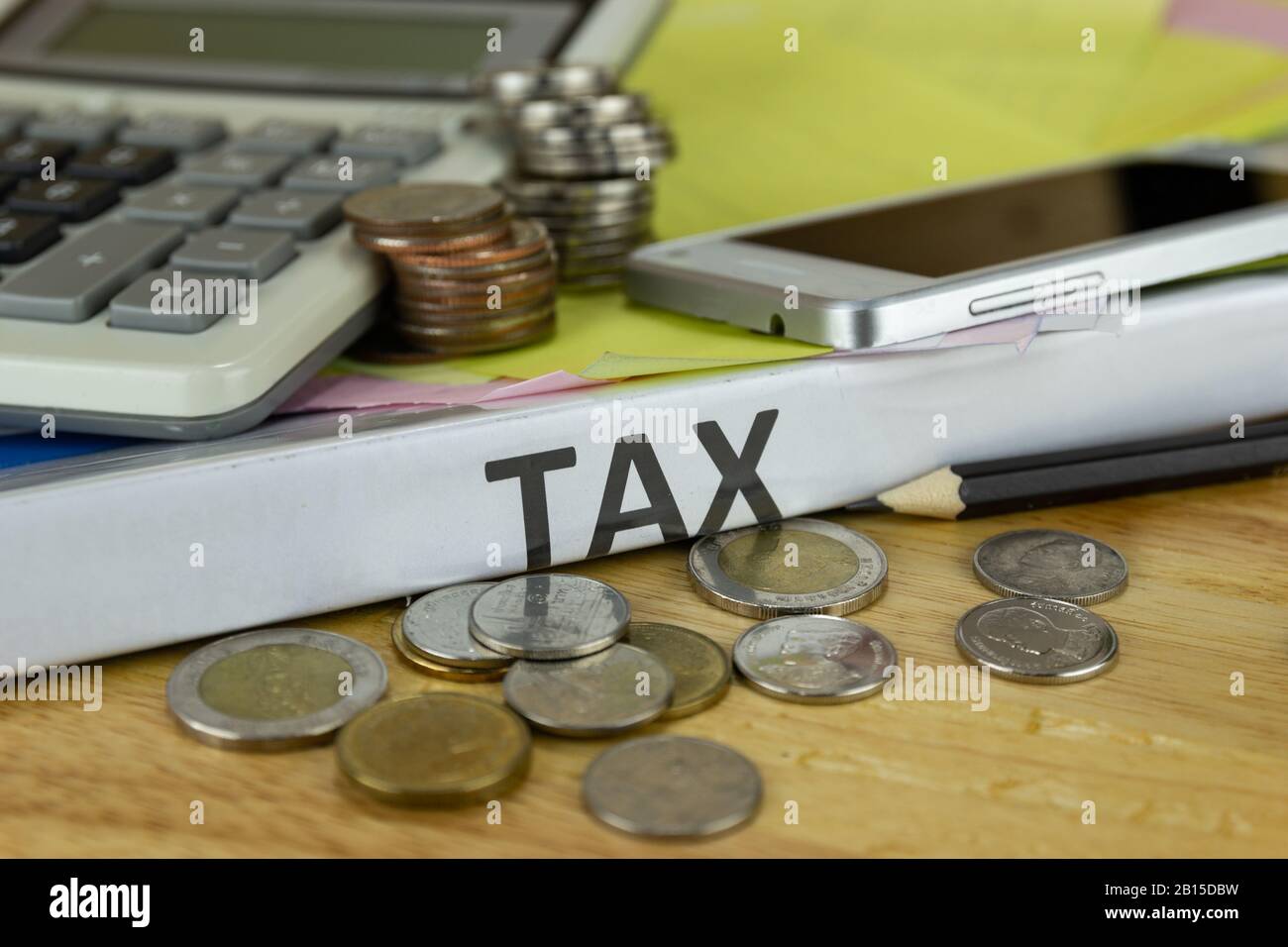 Folder Tax documents and paper files with coin calculator concept ...