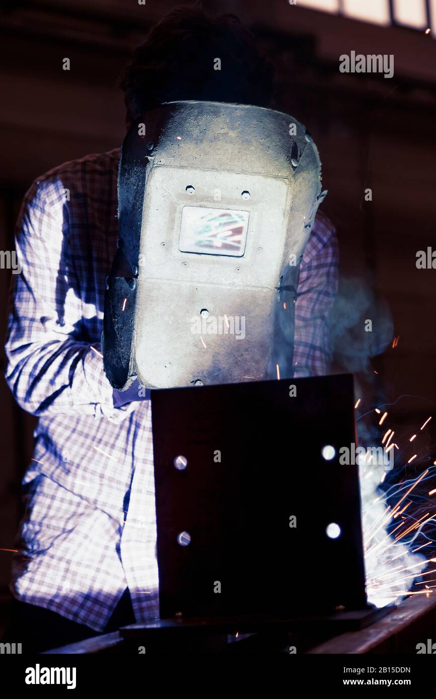young worker while welding steel Stock Photo - Alamy