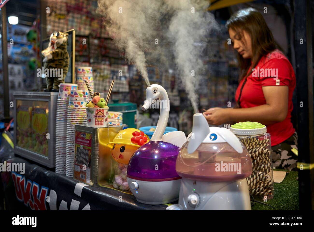 Candy and hot marshmallow stall with steaming pots for heating the ...