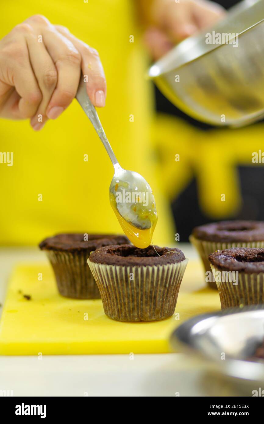 The process of making chocolate cupcakes with sweet cream. Creation of ...