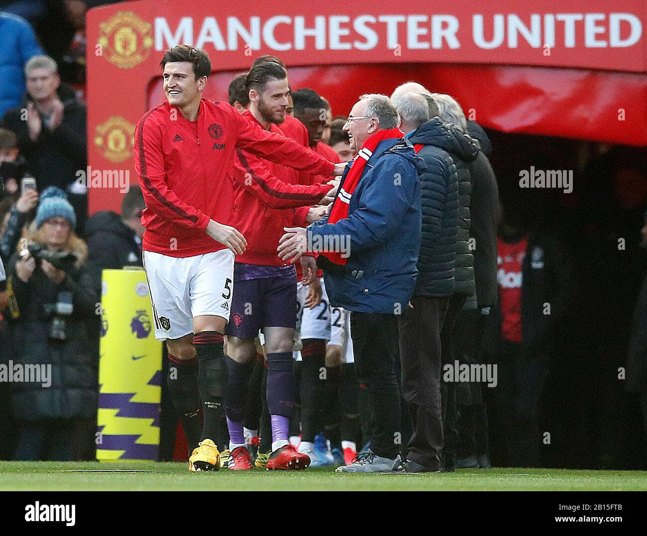 Manchester United's Harry Maguire leads his team out and shakes hands ...