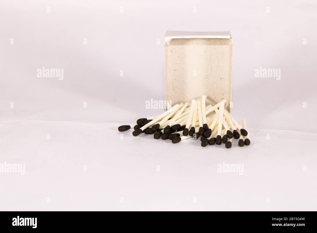 A creative concept of a wax match box with with stick and black head ...