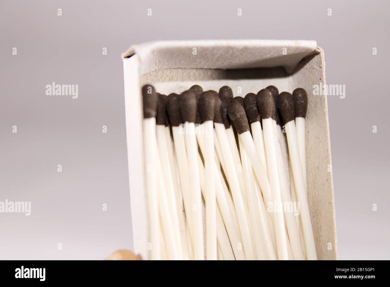 A creative concept of a wax match box with with stick and black head ...