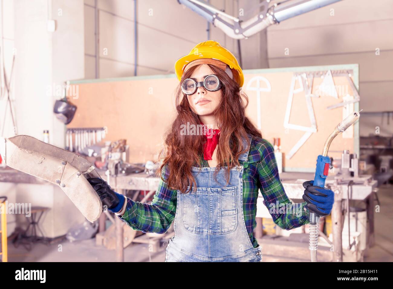 portrait of pretty female worker in a steel mill Stock Photo - Alamy