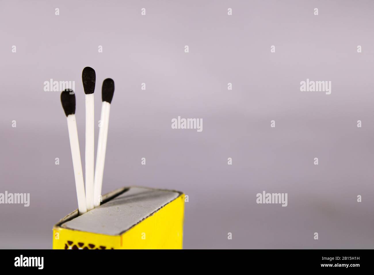 A creative concept of a wax match box with with stick and black head ...