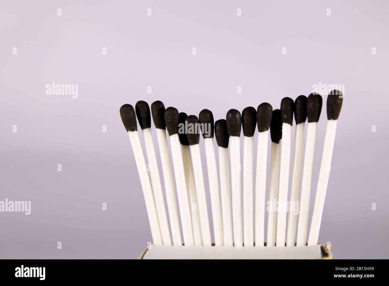 A creative concept of a wax match box with with stick and black head ...