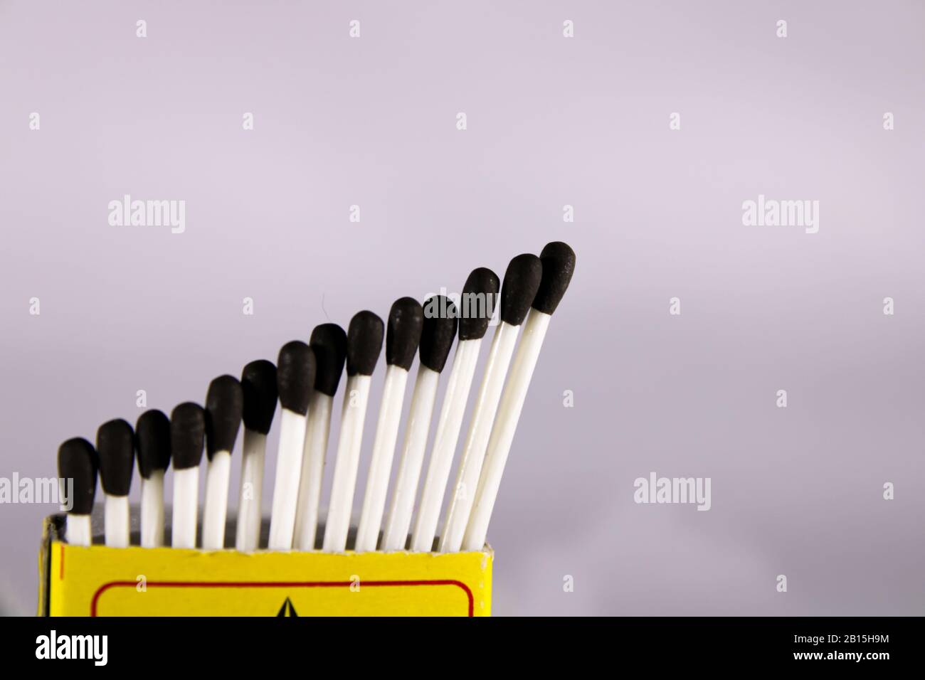 A creative concept of a wax match box with with stick and black head ...