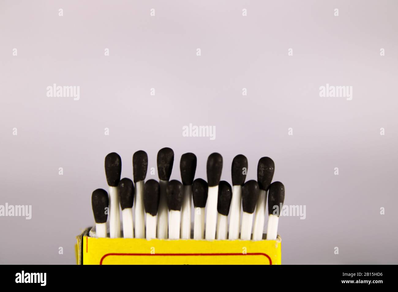 A creative concept of a wax match box with with stick and black head ...