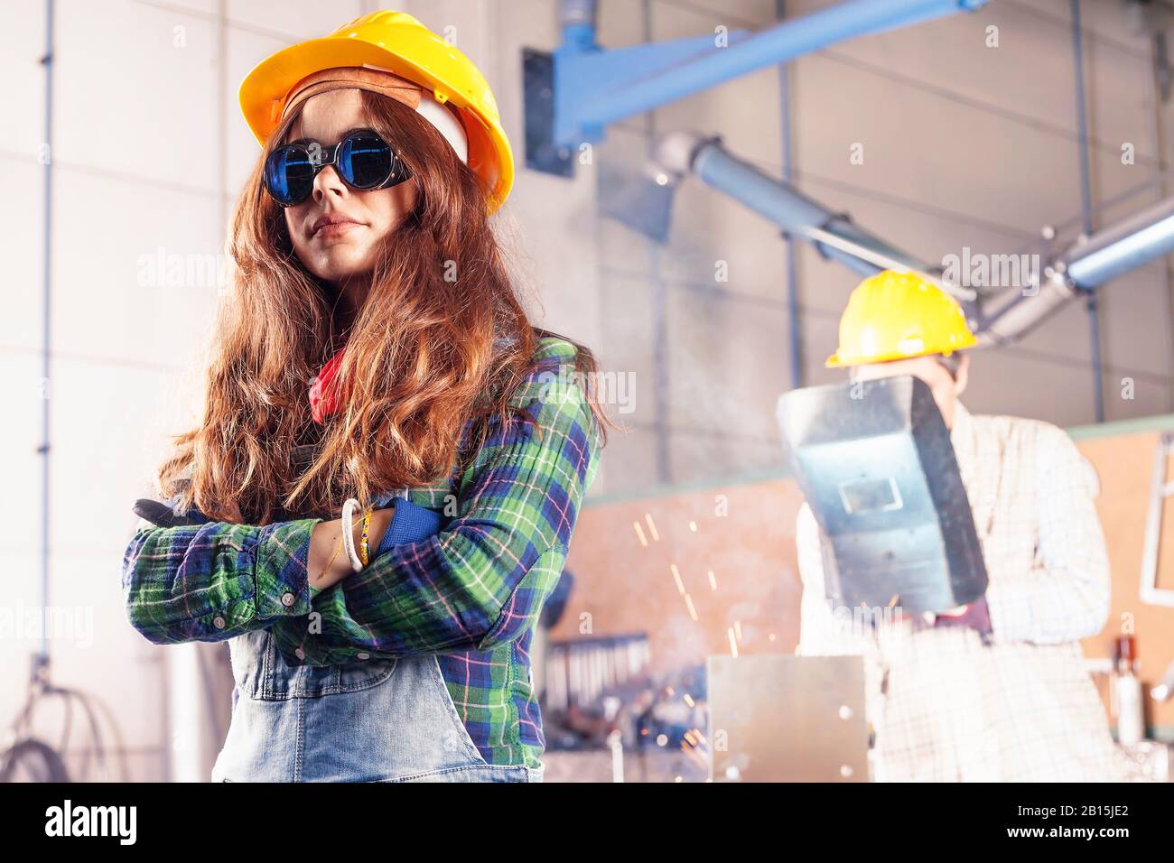 portrait of pretty female worker in a steel mill Stock Photo - Alamy