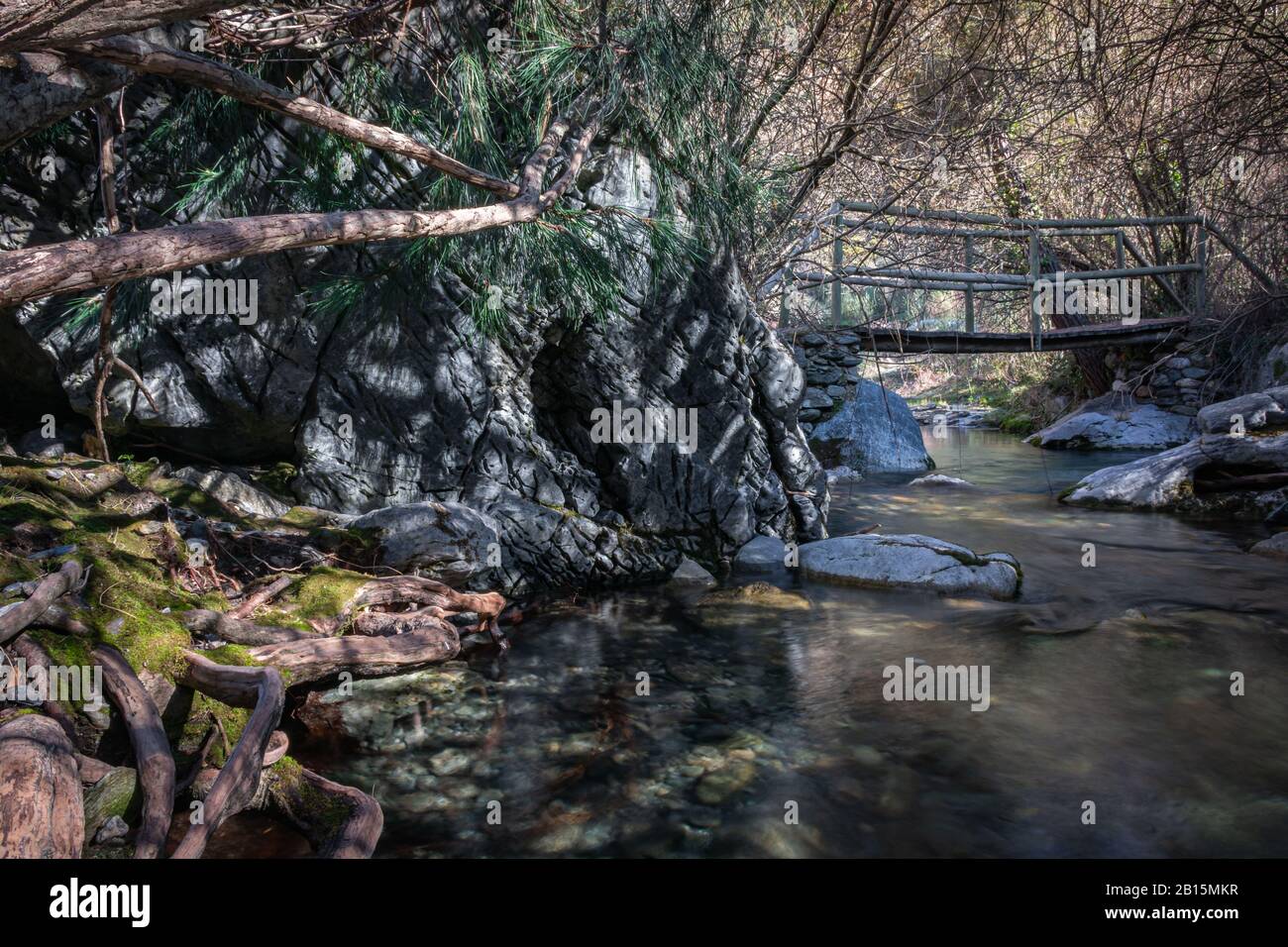 Wooden bridge between trees on the Dilar river Stock Photo - Alamy