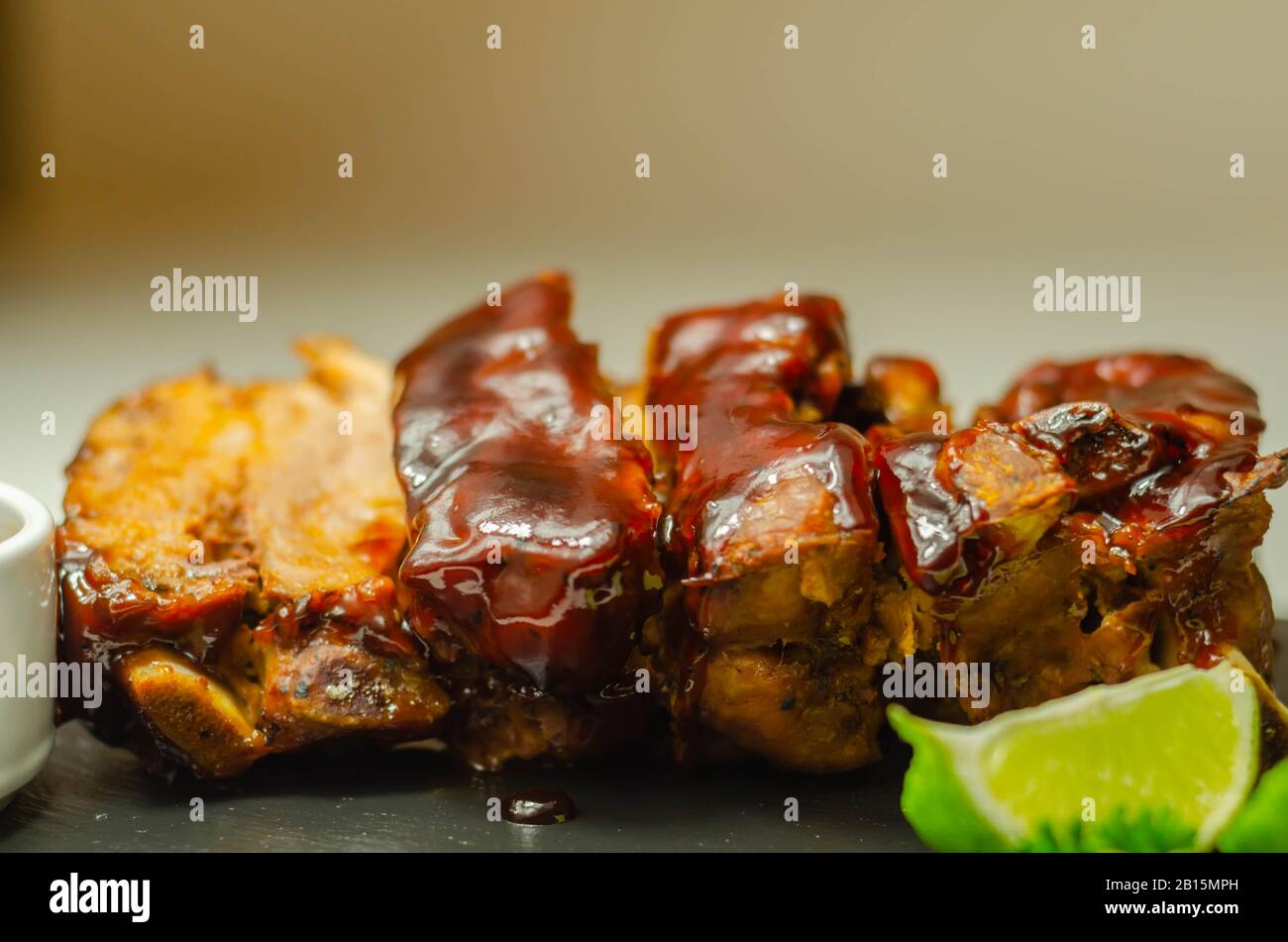 Pork ribs in a smoky flavour barbecue seasoning with a honey barbecue ...