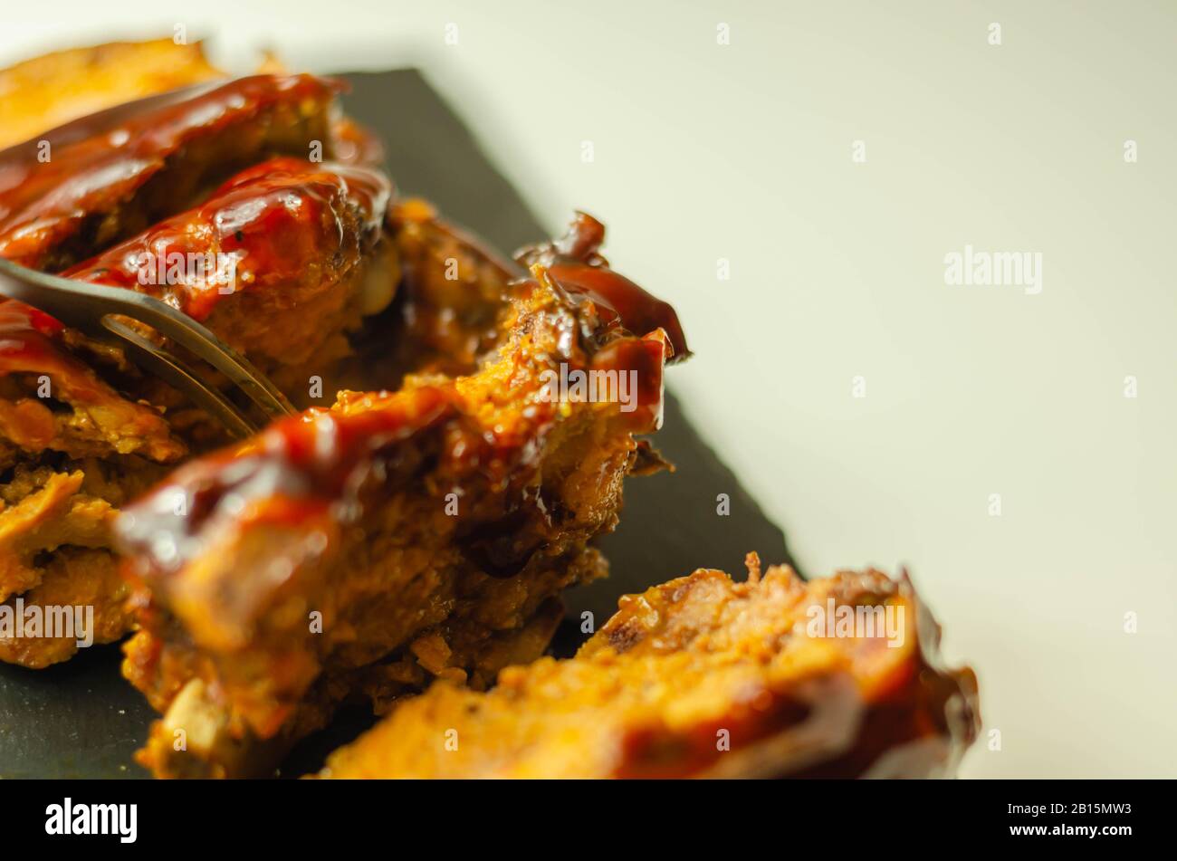 Pork ribs in a smoky flavour barbecue seasoning with a honey barbecue ...