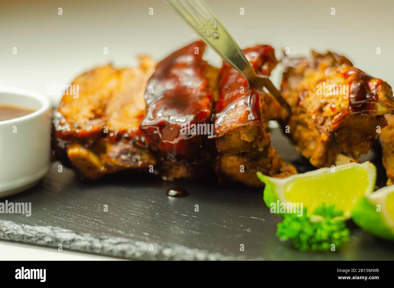 Pork ribs in a smoky flavour barbecue seasoning with a honey barbecue ...