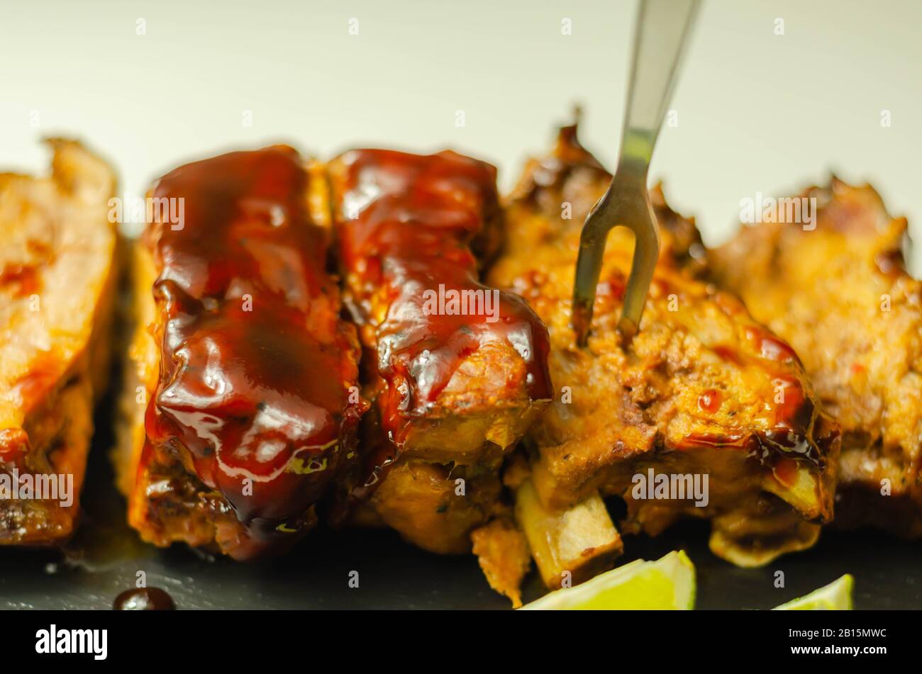 Pork ribs in a smoky flavour barbecue seasoning with a honey barbecue ...