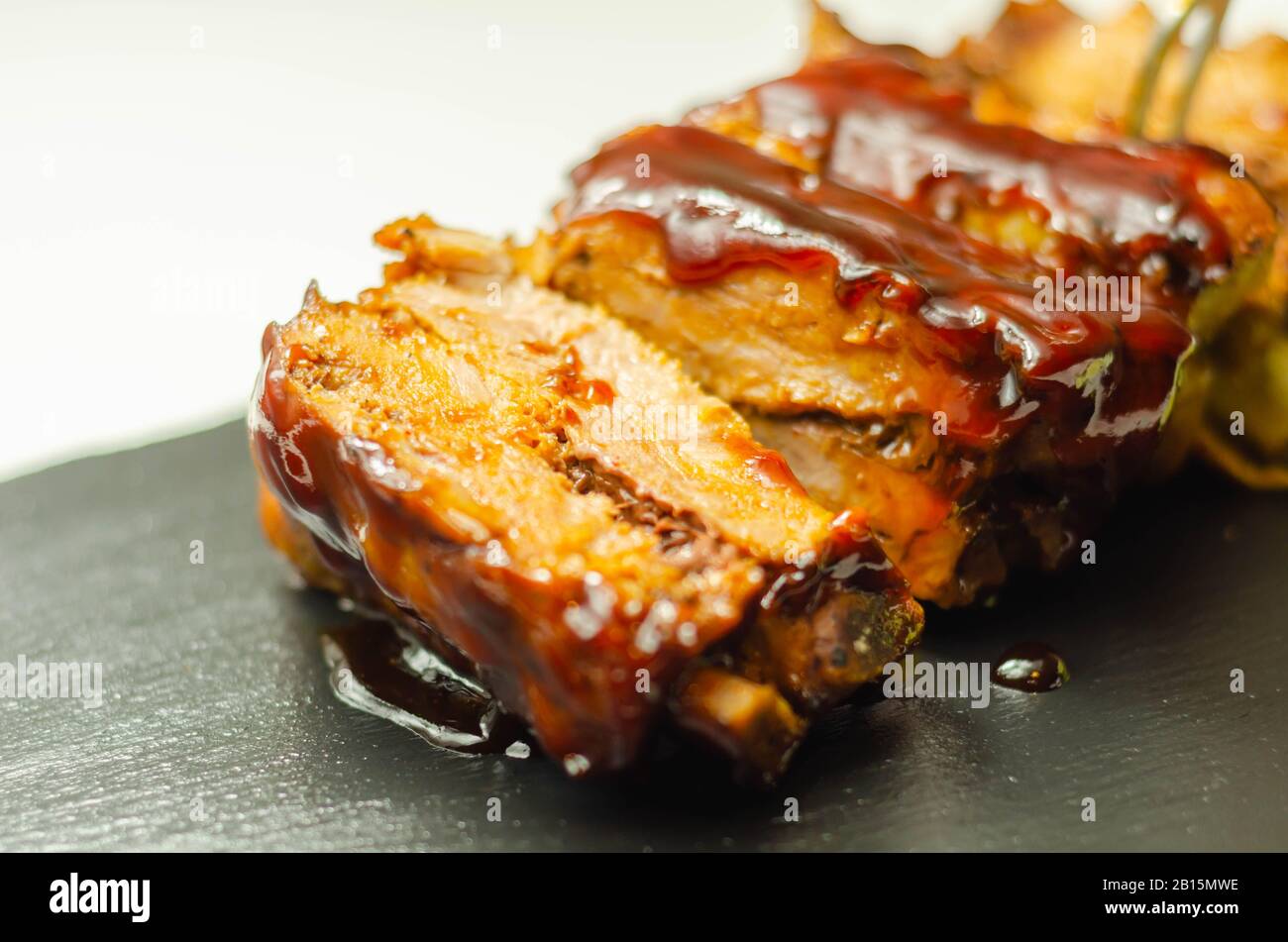Pork ribs in a smoky flavour barbecue seasoning with a honey barbecue ...