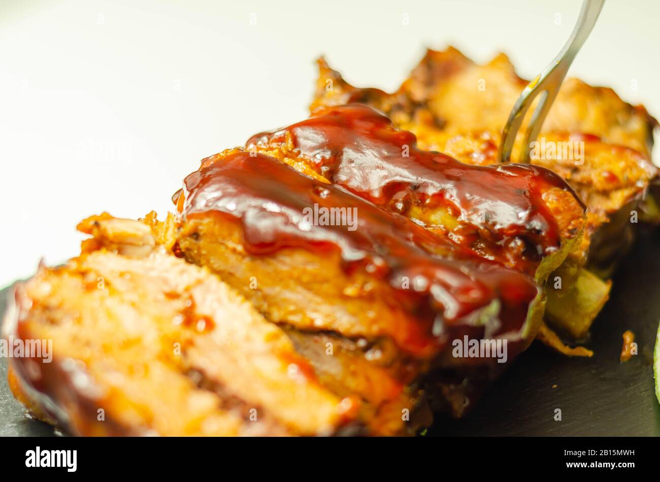 Pork ribs in a smoky flavour barbecue seasoning with a honey barbecue ...