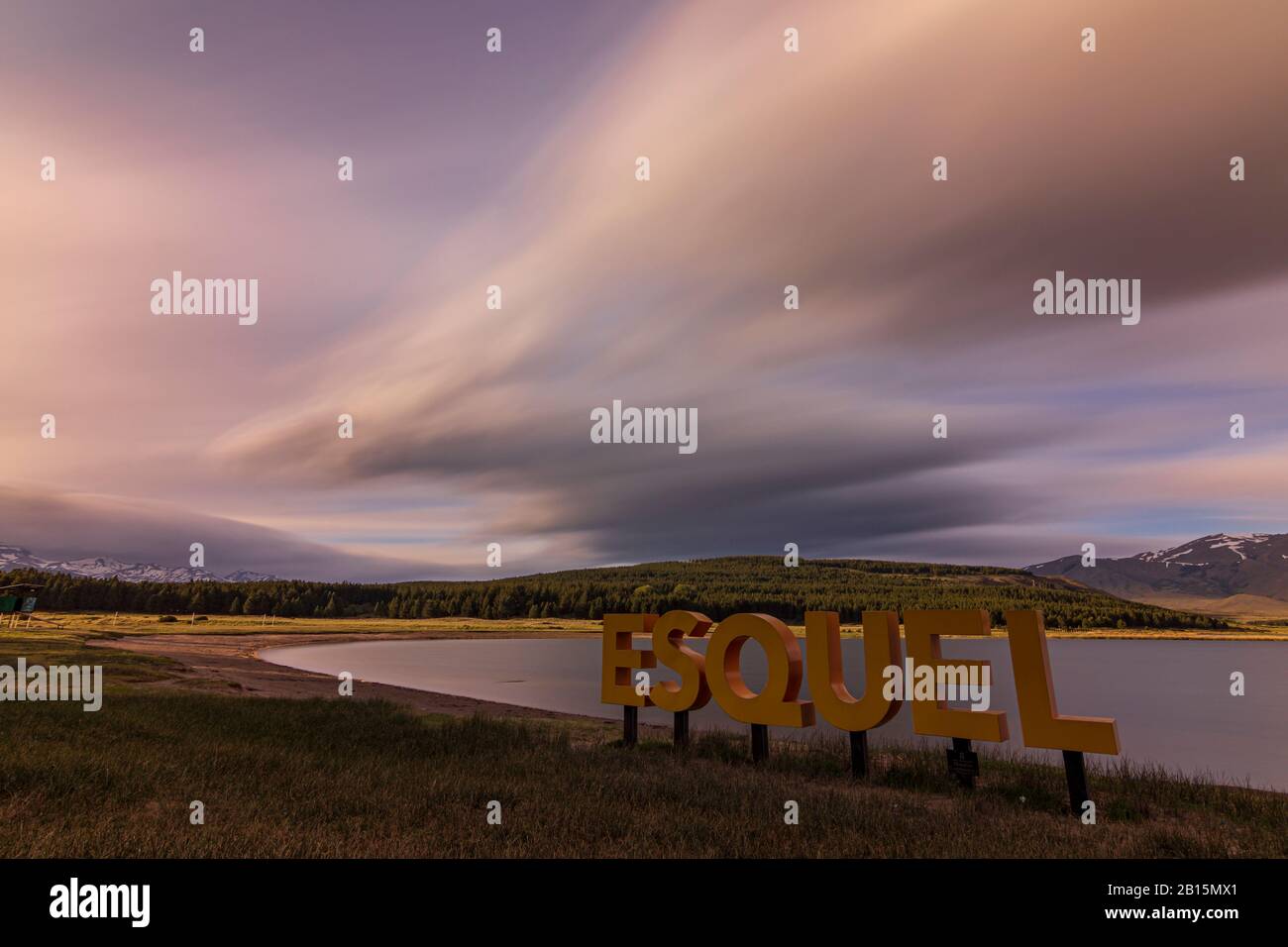 Landscape view of Esquel city name sign against lake beneath stunning ...