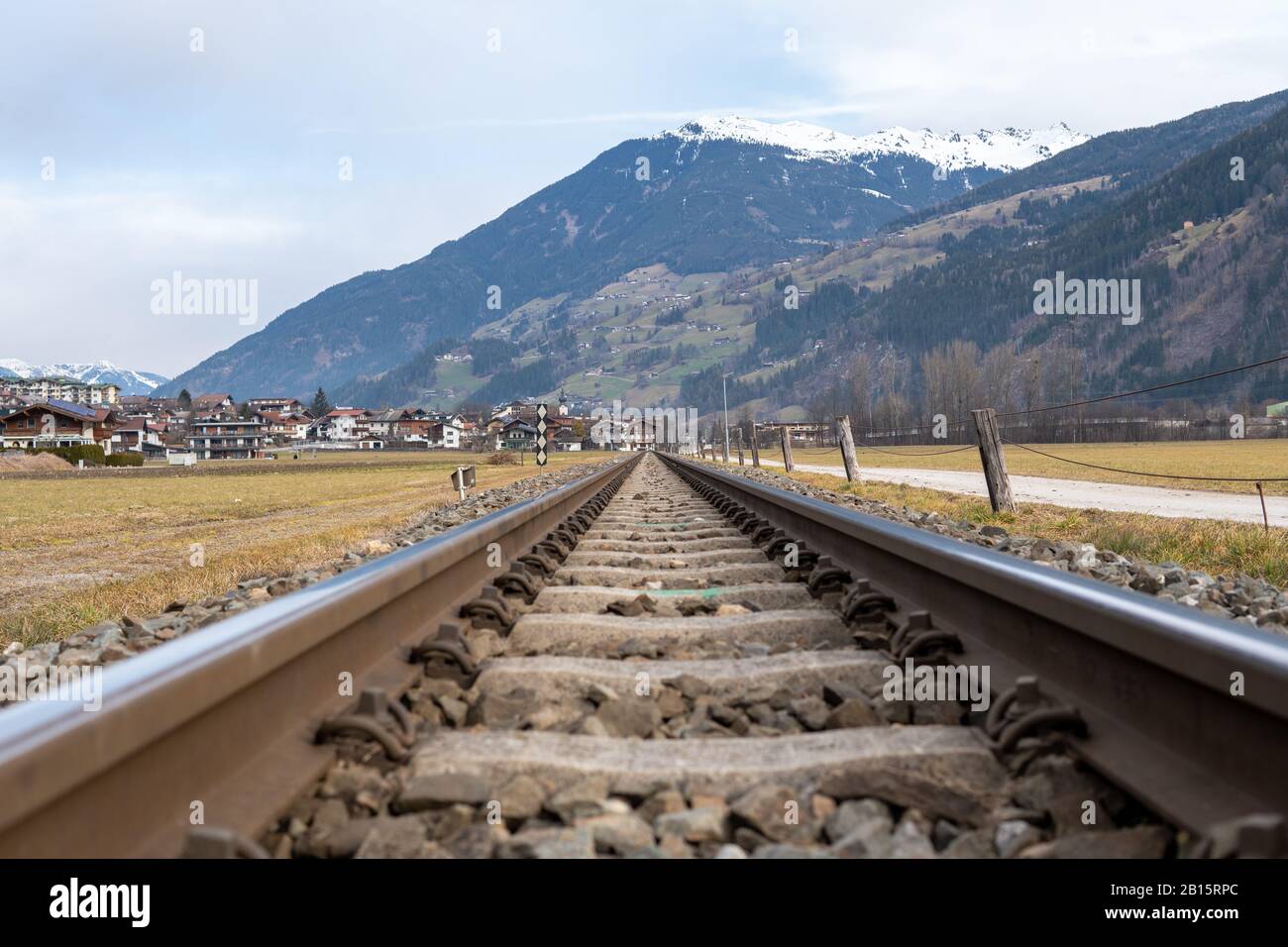 Railway tracks lead through the valley of the Austrian Alps Stock Photo ...
