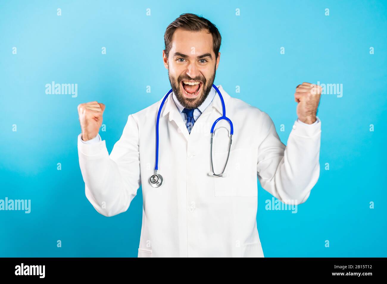Portrait of happy excited doctor in professional medical white coat ...