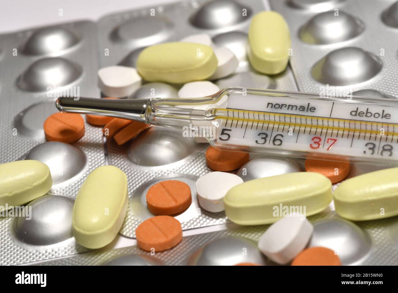 medicine pills with fever thermometer Stock Photo - Alamy