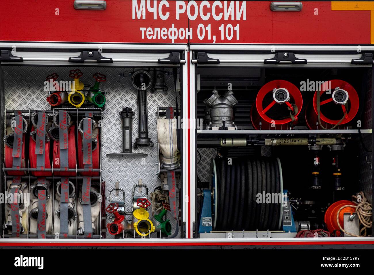 Cabinet with fire hoses and equipment for extinguishing a fire in a ...