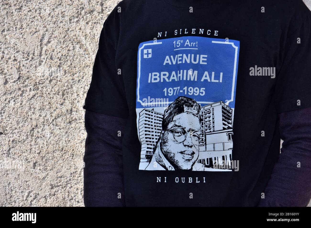 A man wears a T-shirt depicting the French Comorian boy Ibrahim Ali ...