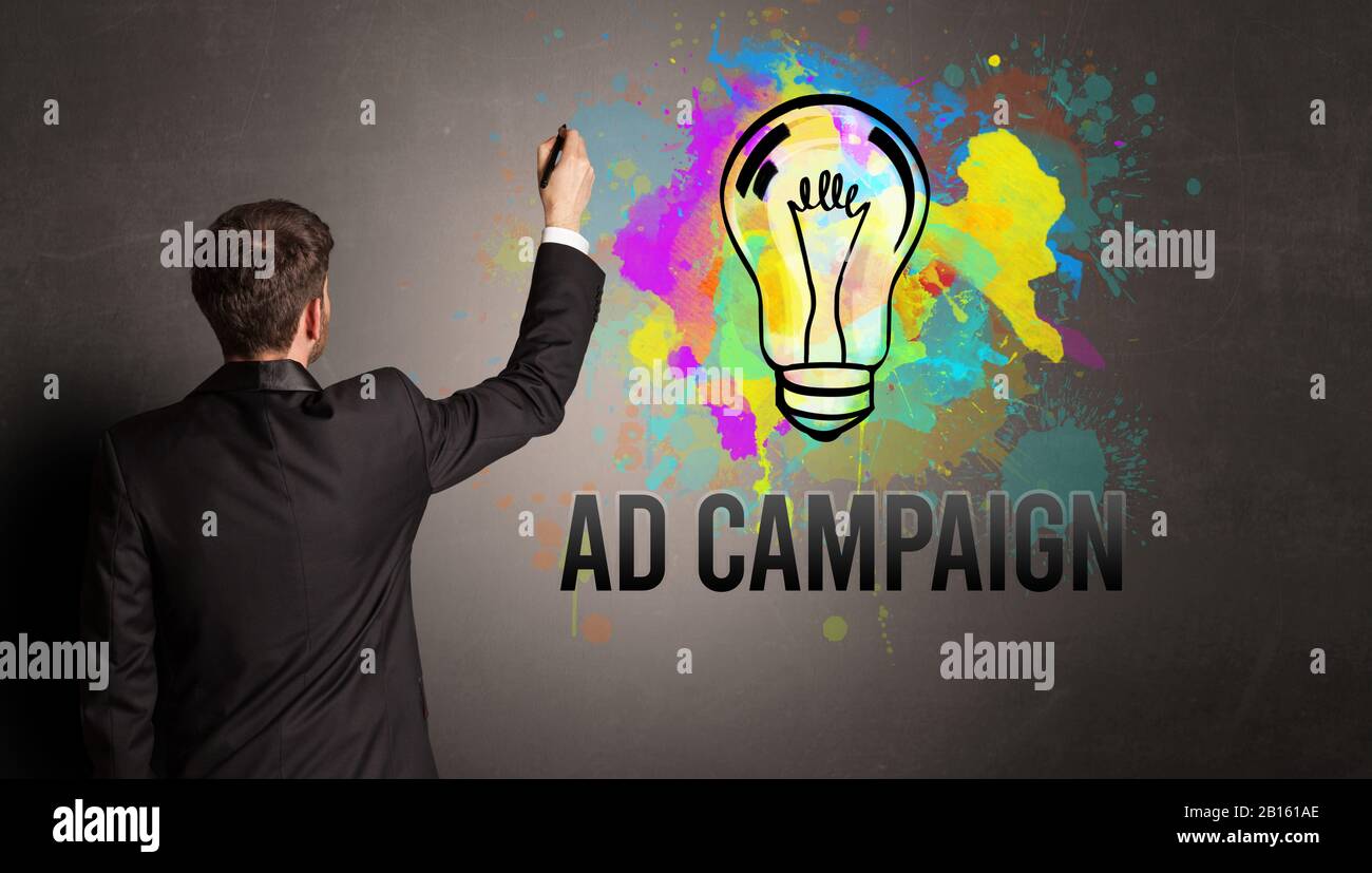 businessman drawing colorful light bulb with AD CAMPAIGN inscription on ...