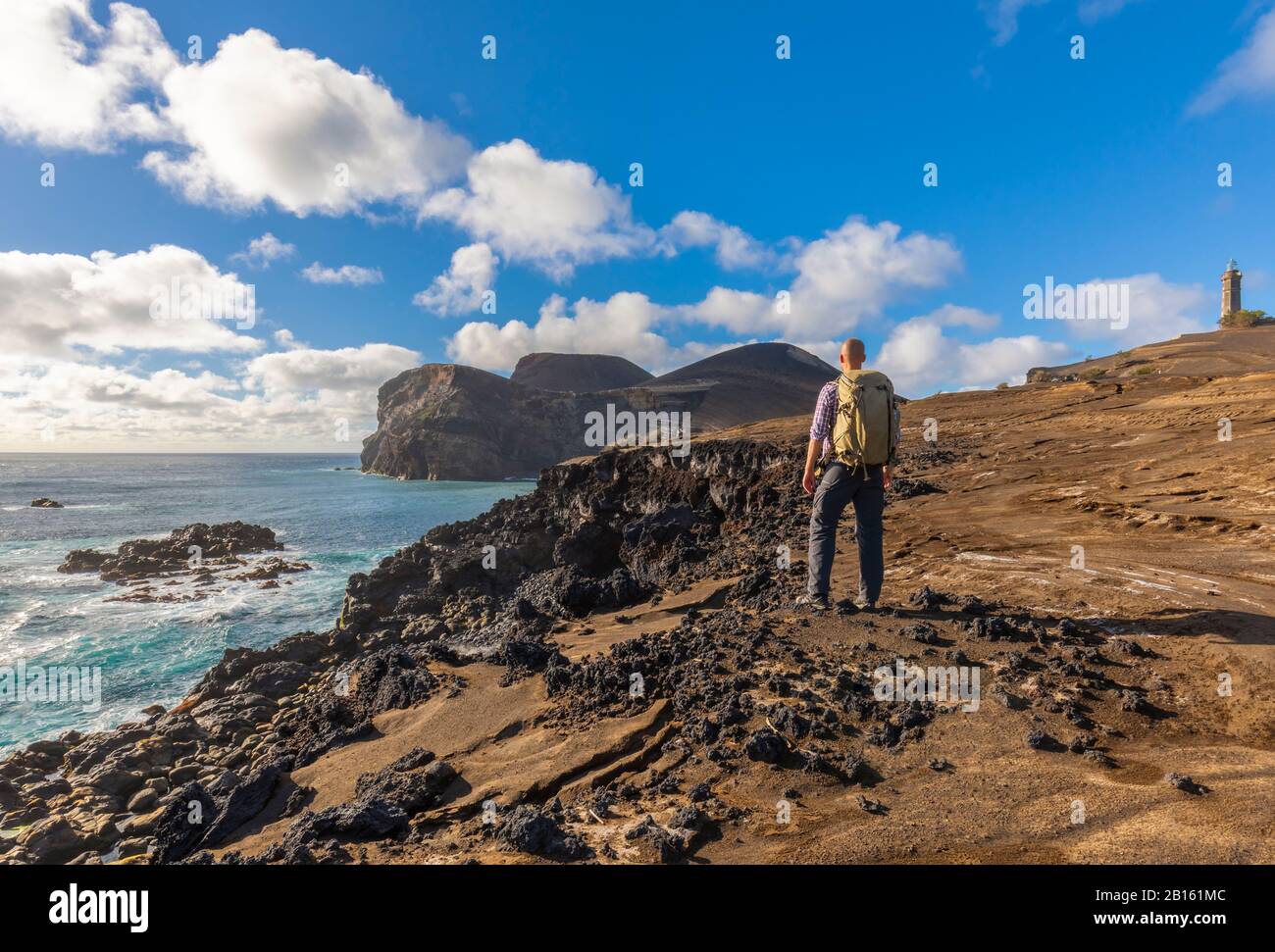 A man at Capelinhos volcano at sunset, Capelo, Faial, Azores, Portugal ...