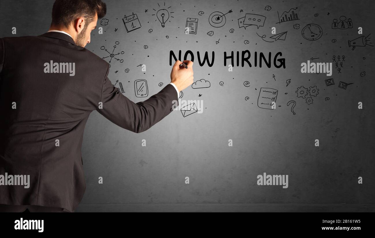 businessman drawing a creative idea sketch with NOW HIRING inscription ...