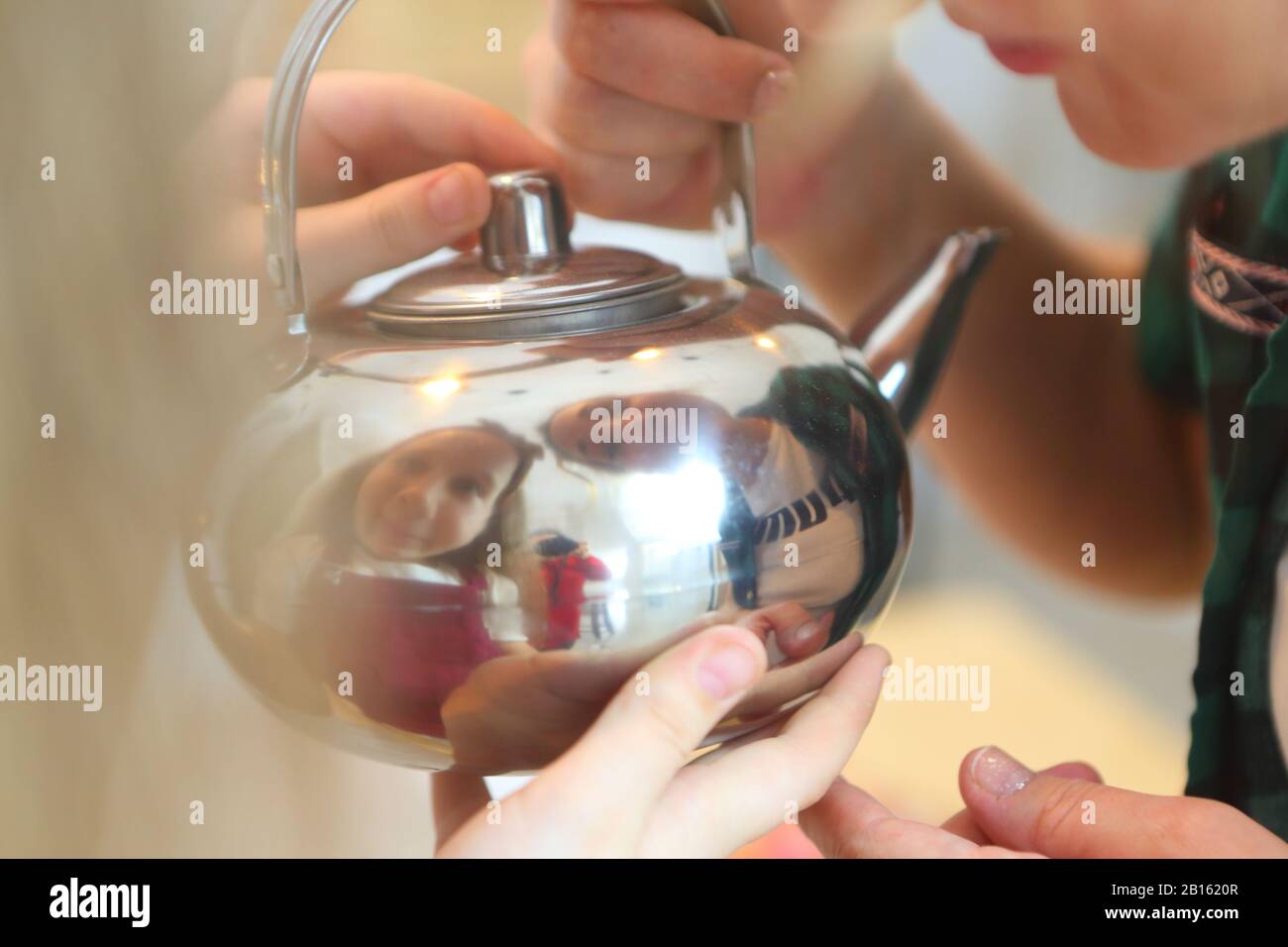 Girl holding a kettle Stock Photo - Alamy