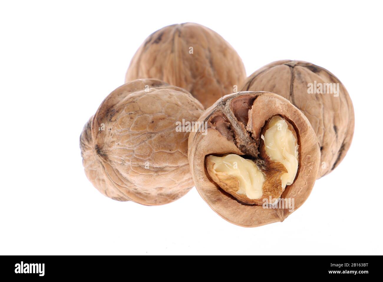 Whole and cracked walnuts isolated on white background Stock Photo - Alamy