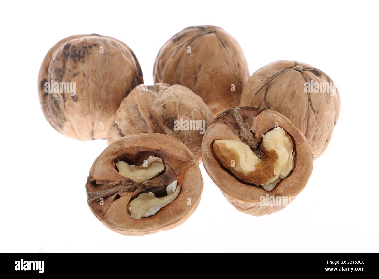 Whole and cracked walnuts isolated on white background Stock Photo - Alamy