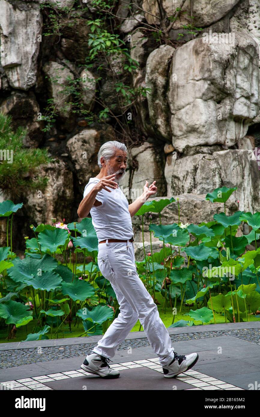 Fit elderly Chinese man dancing in Chengdu People's Park China Stock ...