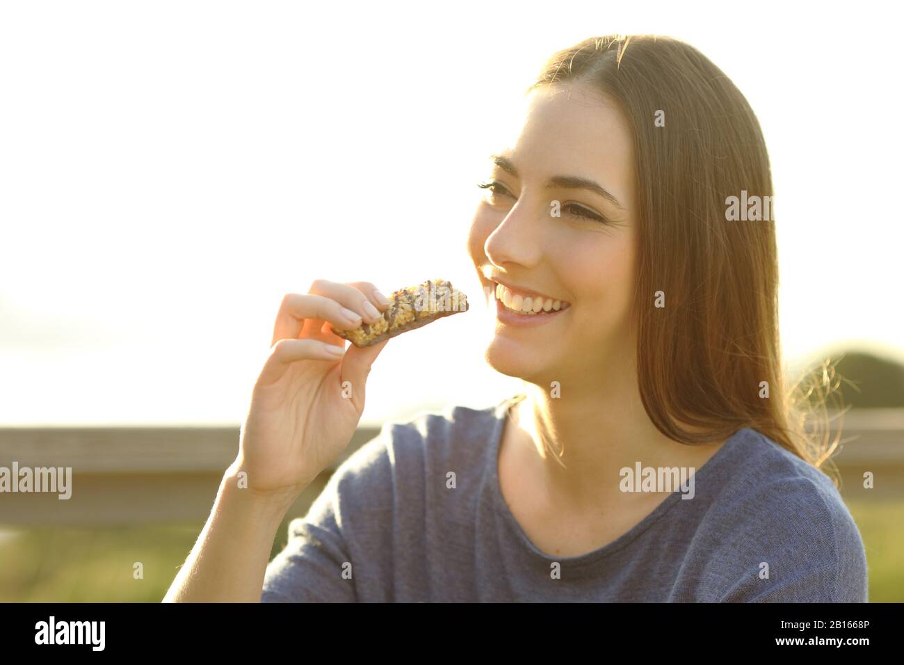 Lady eating granola bar hi-res stock photography and images - Alamy