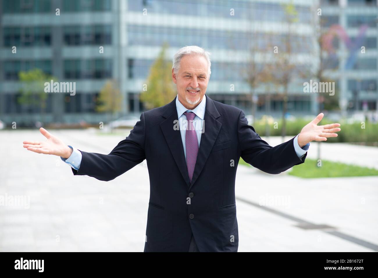 Senior businessman with open arms Stock Photo - Alamy
