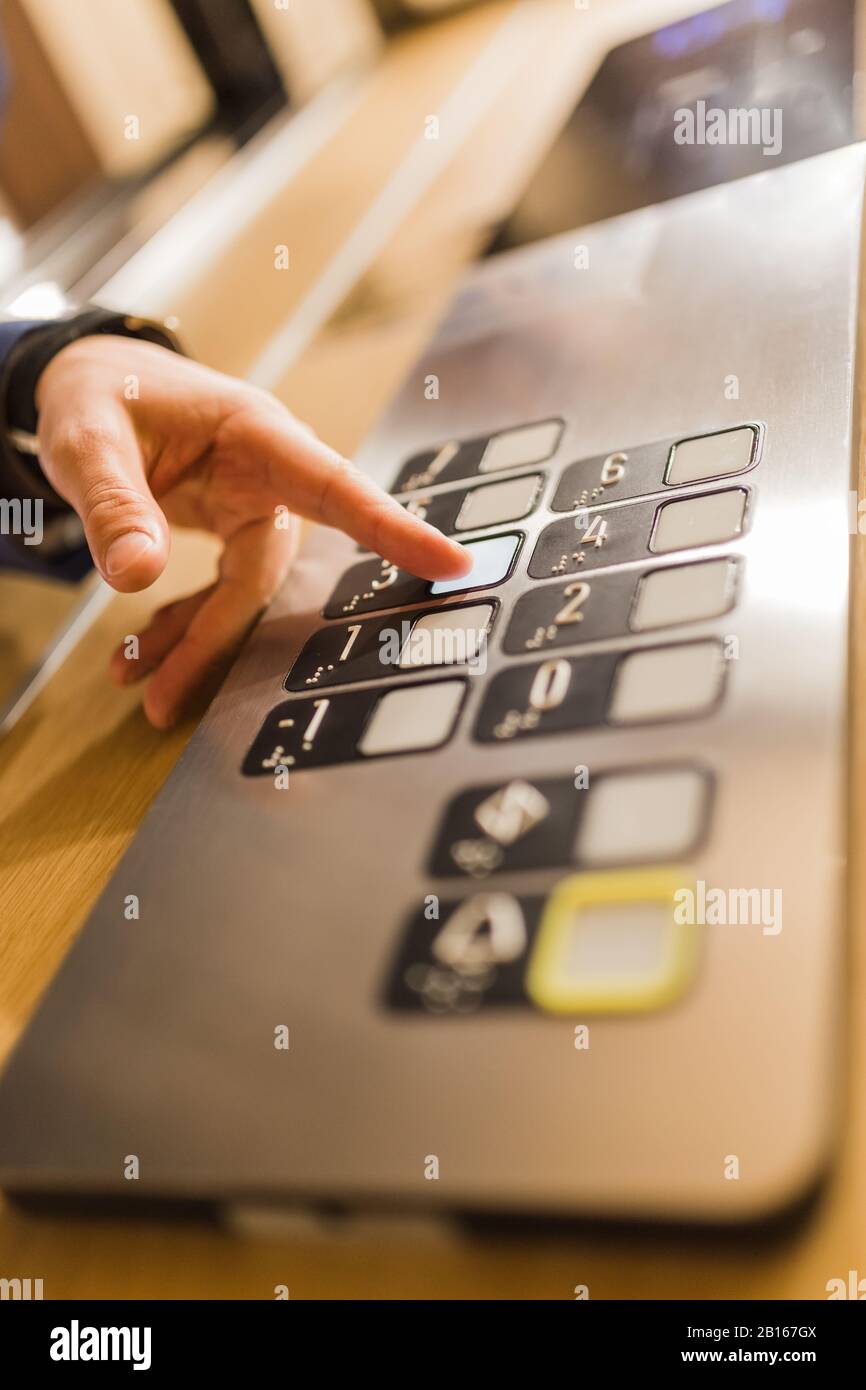Man pressing modern elevator button with his forefinger Stock Photo - Alamy