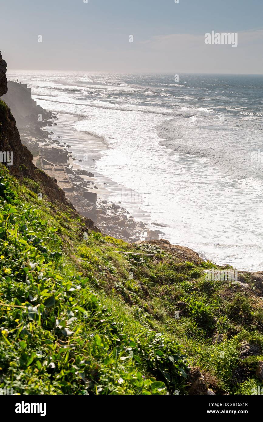 Ocean coast with grass, moviment waves with foam. Wind power. Turquoise ...