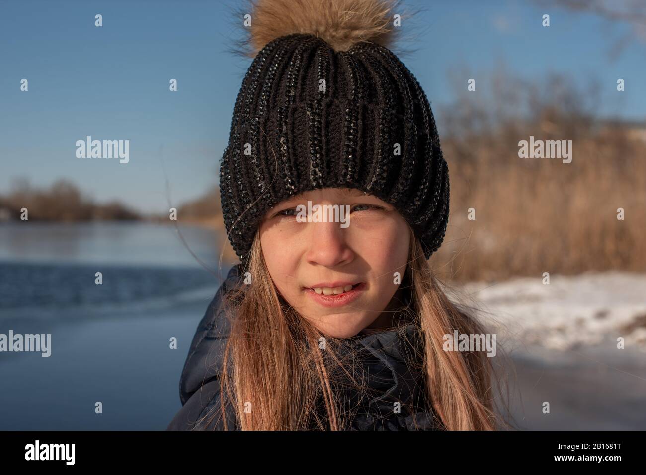 girl on the background of winter lake. view of the frozen lake or river ...