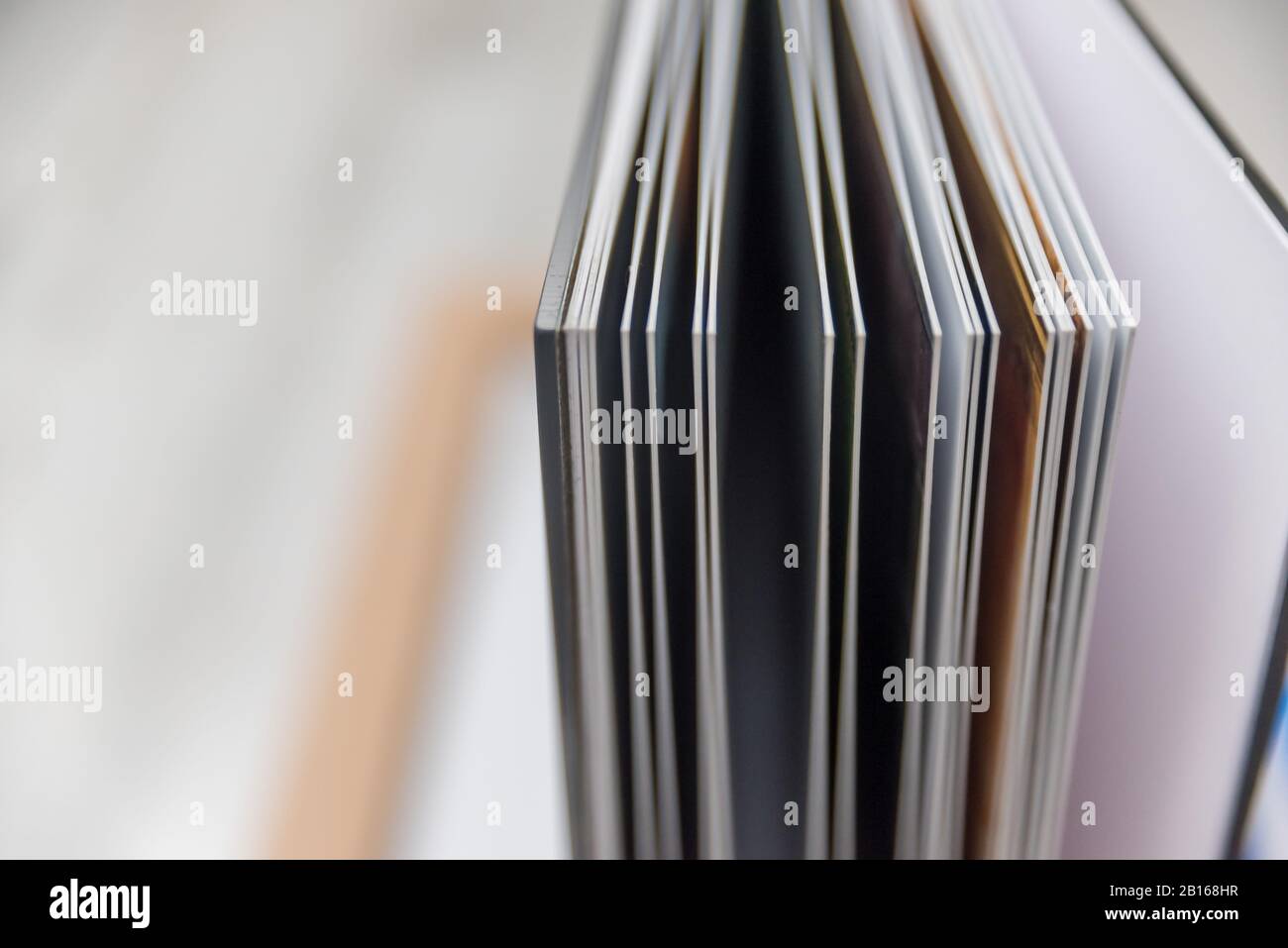 Side view close up of thick and rigid wedding album pages in a book ...