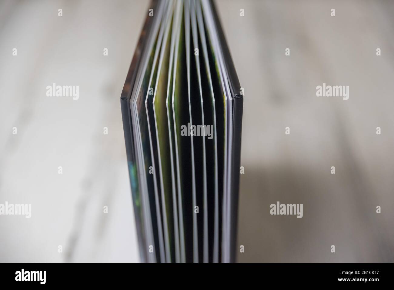 Side view close up of thick and rigid wedding album pages in a book ...