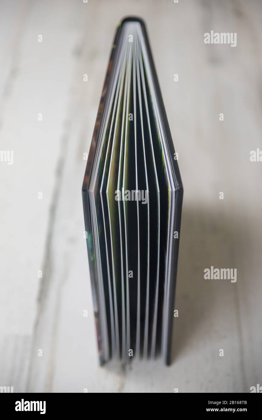 Side view close up of thick and rigid wedding album pages in a book ...