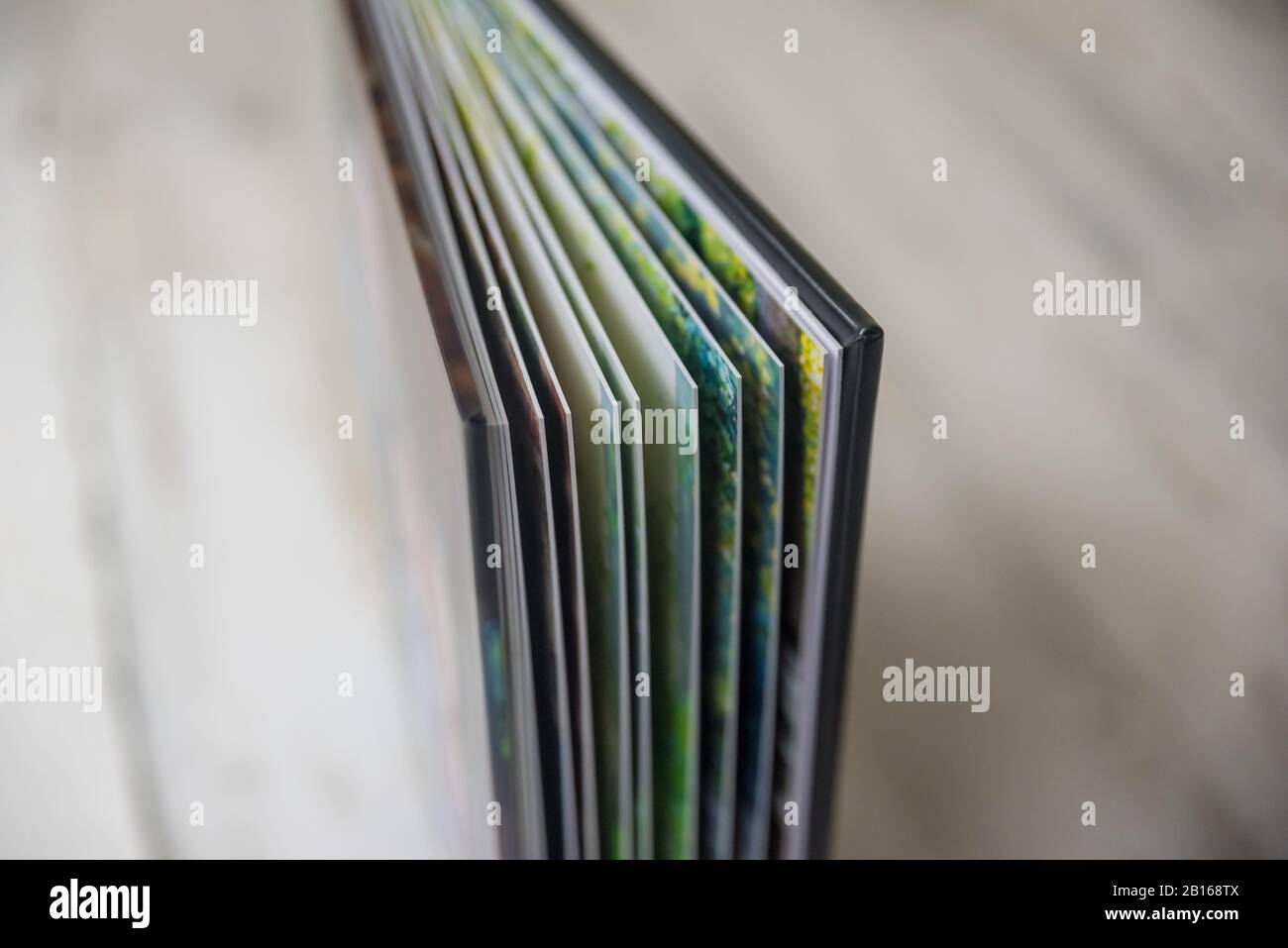Side view close up of thick and rigid wedding album pages in a book ...