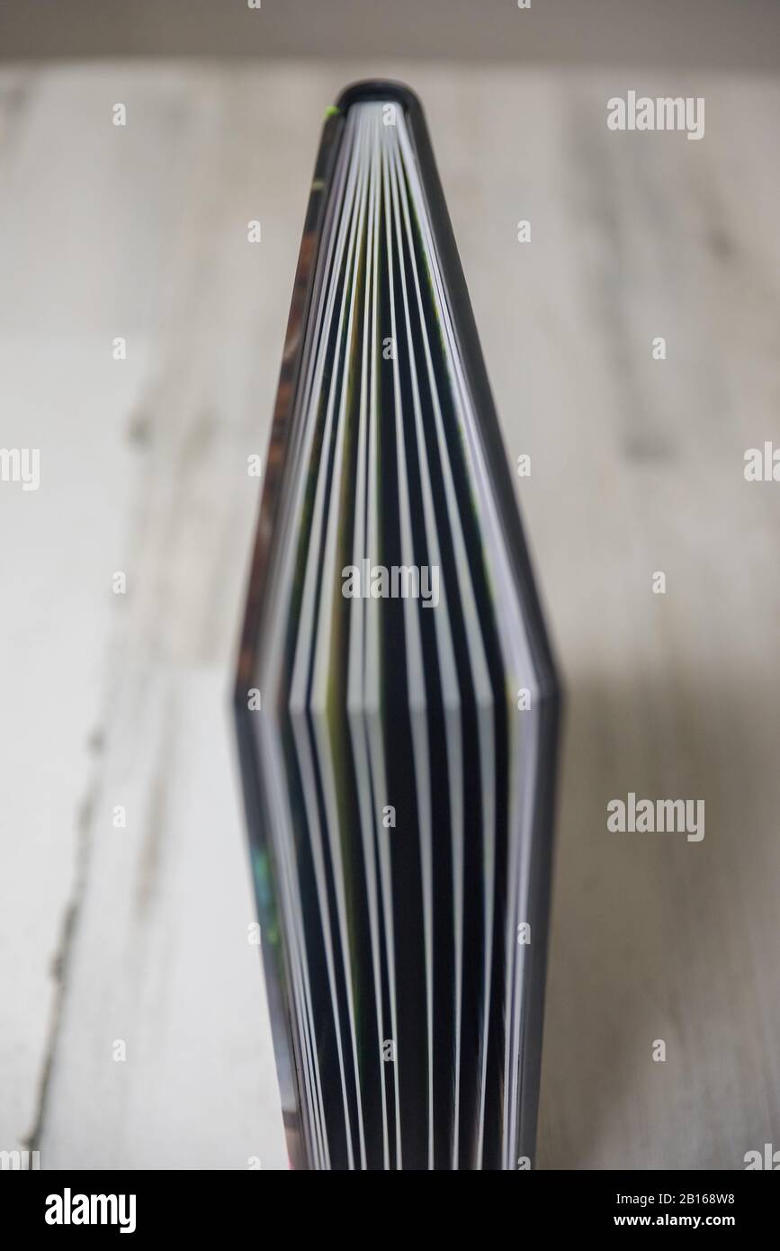 Side view close up of thick and rigid wedding album pages in a book ...