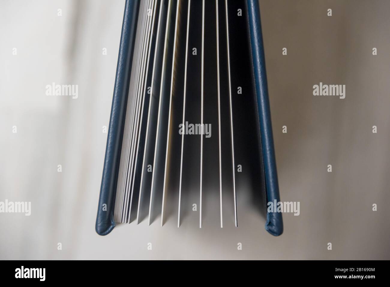 Top view close up of thick and rigid wedding album pages in a navy blue ...