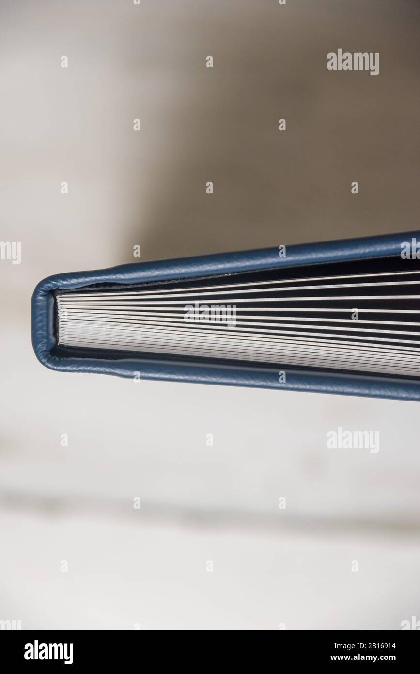 Top view close up of thick and rigid wedding album pages in a navy blue ...