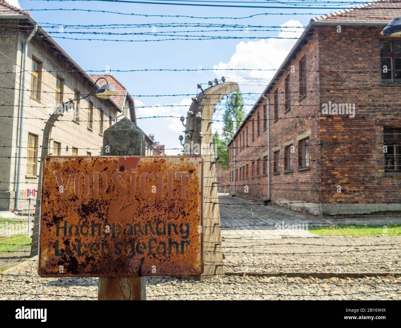 Barbed wire and brick barracks buildings of Auschwitz Concentration ...