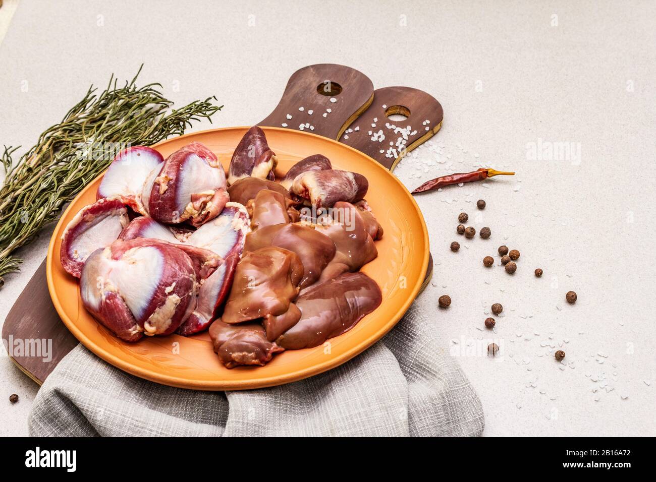 Fresh raw duck offal: heart, liver, stomach. Dry spices, salt, chili ...