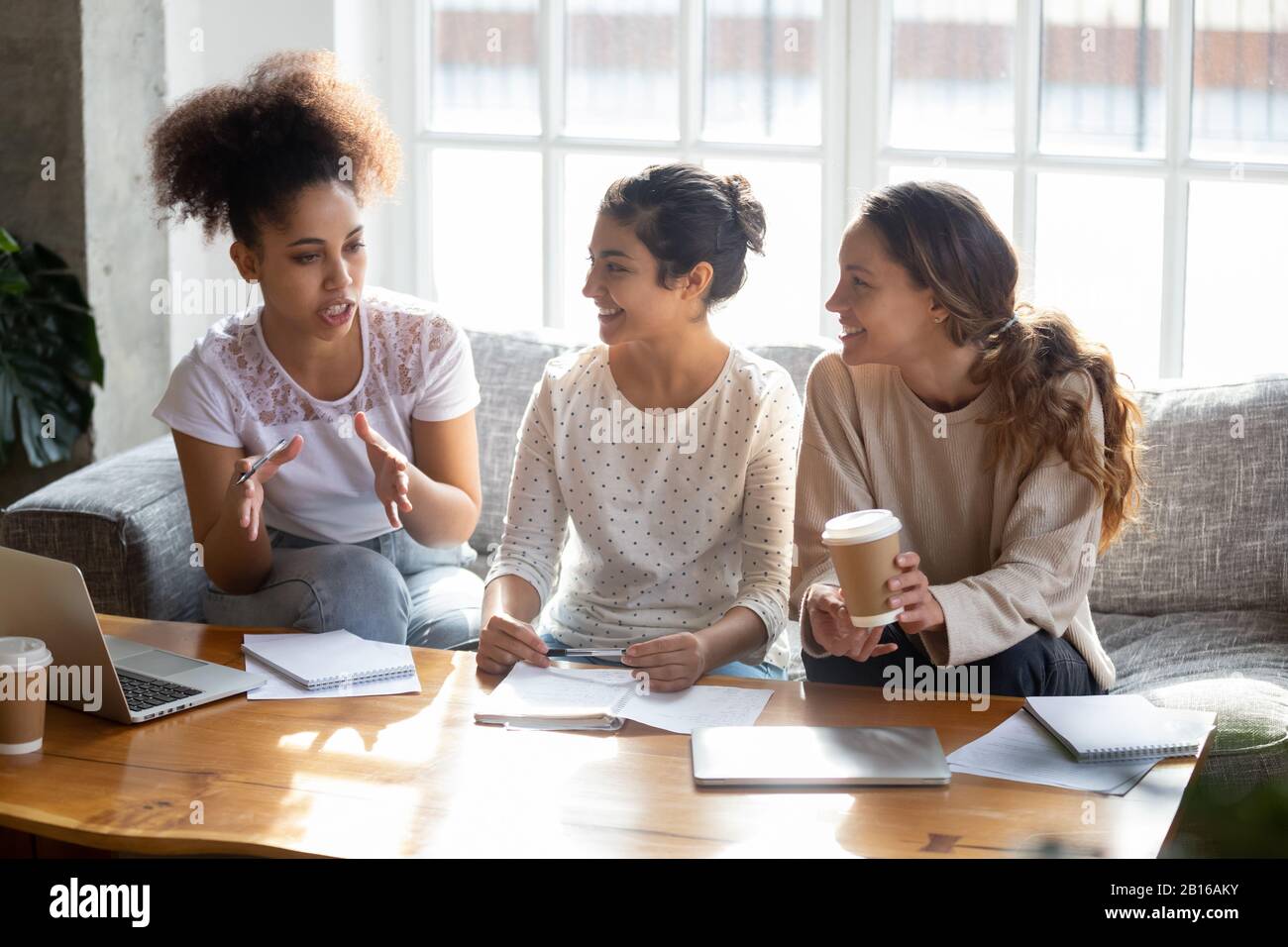 Three diverse student girls studying do college research project ...