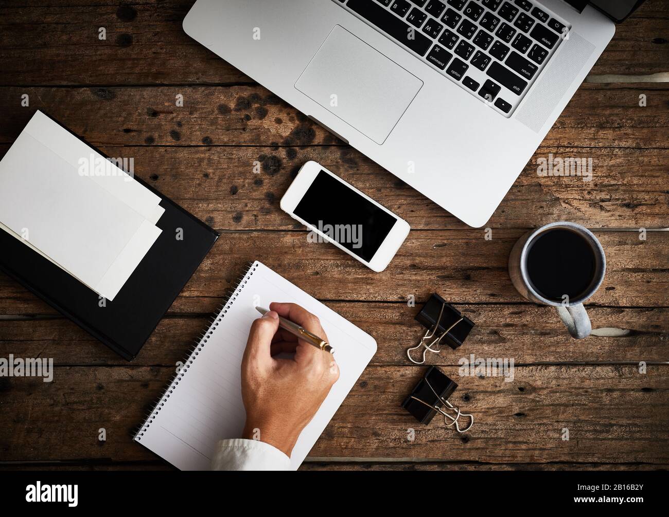 Smartphone white screen on wooden table.Top view Stock Photo - Alamy