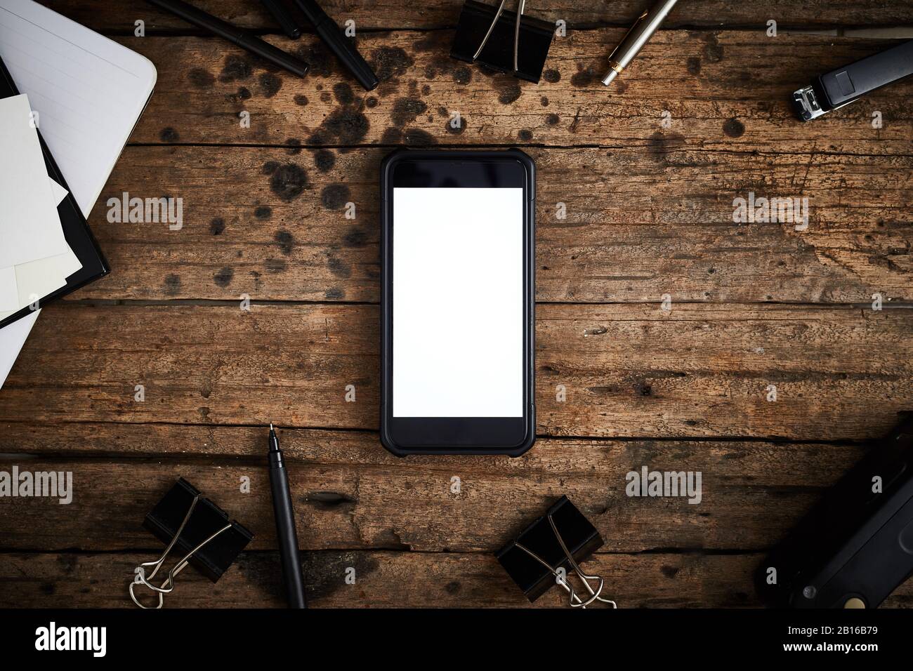 Smartphone white screen on wooden table.Top view Stock Photo - Alamy